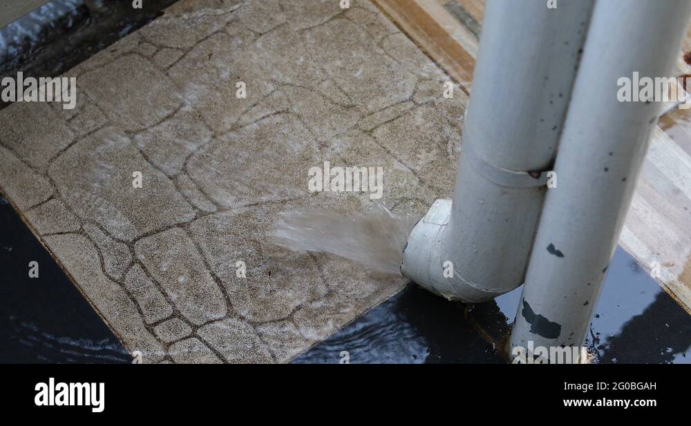 rain water flowing in tube pipe drain from gutter roof house Stock ...