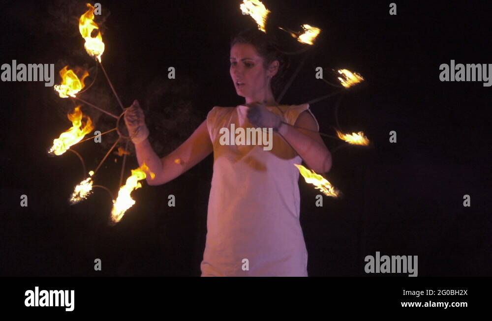 Fiery dance. Amazing magical Fire Show at night. Slow shutter speed ...