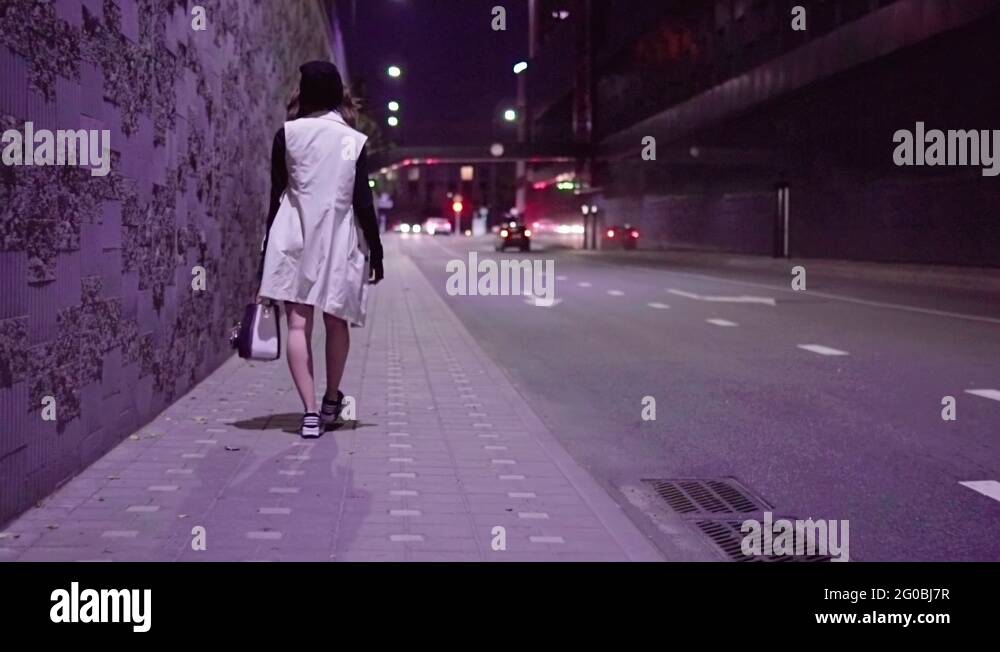 Teenage girl walking in night city Stock Video Footage - Alamy