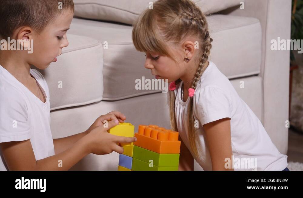 Boy and girl playing colored lego pieces Stock Video Footage - Alamy