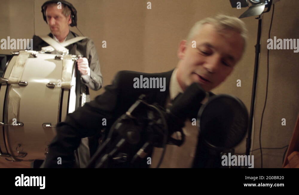 Three musicians and a cheerful fat girl sing and dance in the recording ...