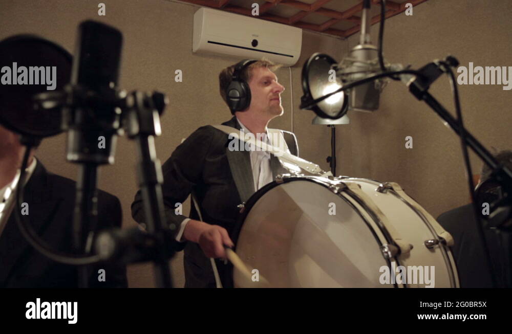 Three musicians and a cheerful fat girl sing and dance in the recording ...