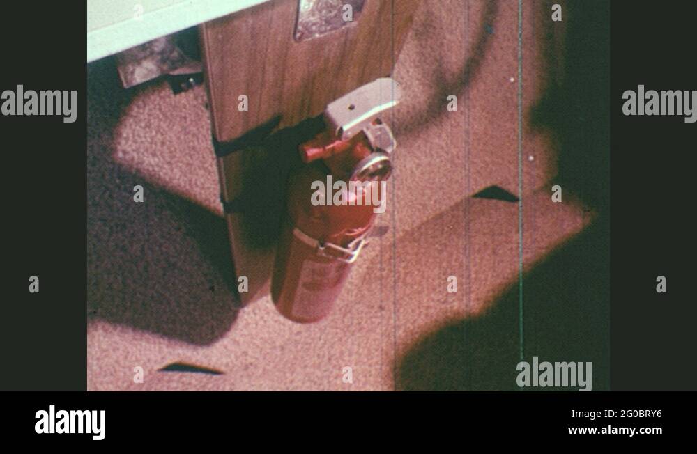 1970s: Fire Extinguisher On Boat. Man Doubled Over In Pain On Boat With ...