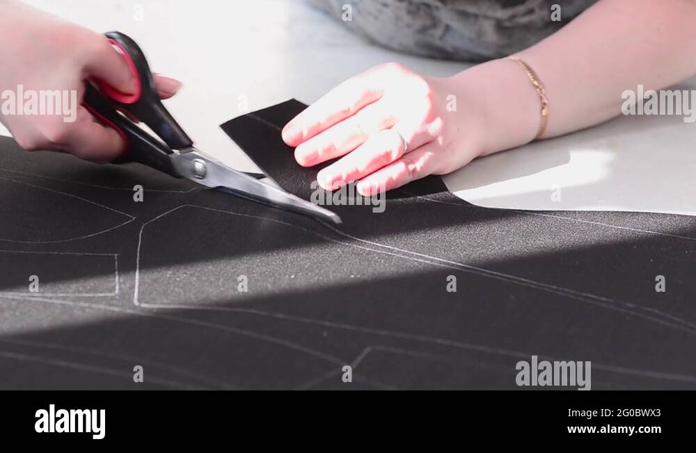 Seamstress cuts scissors with curl on her skin Stock Video Footage - Alamy