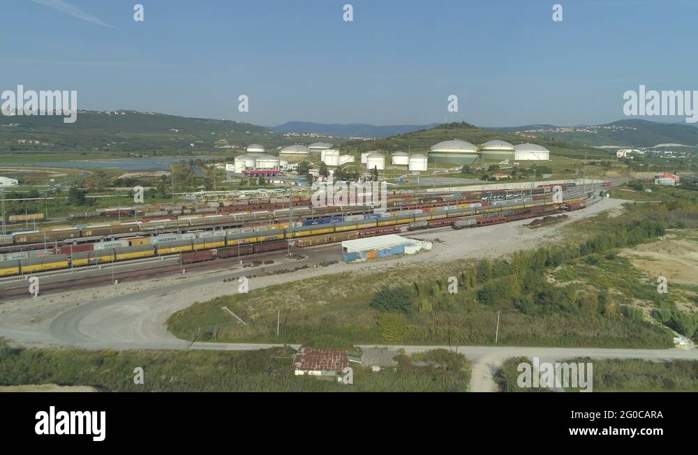 AERIAL: Flying over industrial train station with cargo containers and ...
