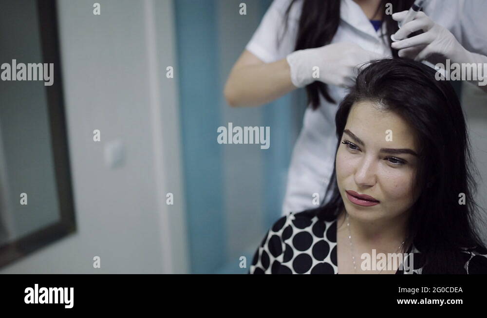 Handsome woman receiving an injection in the head. mesotherapy. Thrust ...