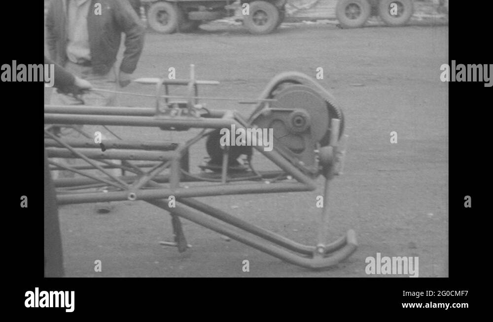 1940s: Men Next To Catapult, Man Pulls Wire, Pan Across Catapult. Men ...