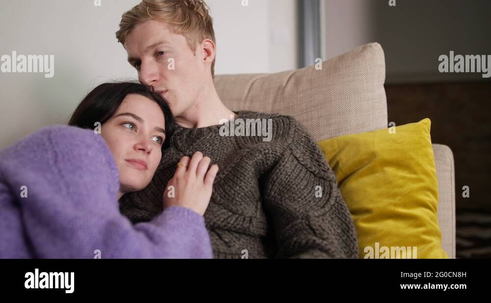 Couple cuddling sofa Stock Videos & Footage - HD and 4K Video Clips - Alamy