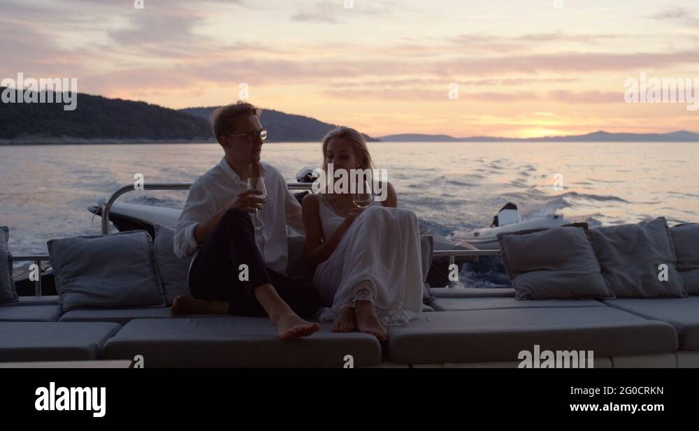 Young Couple Hug, Drink Champagne in the Stern of the Moving Yacht ...