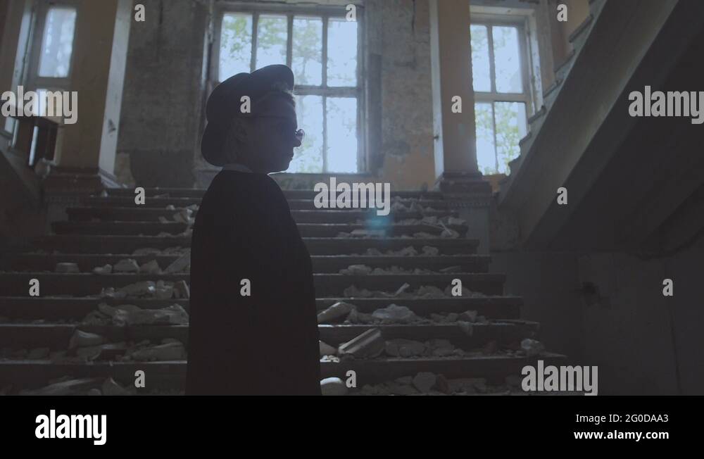girl in a hat walks in a ruined building Stock Video Footage - Alamy