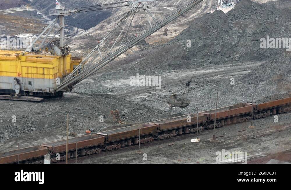 Excavator loading of iron ore on train Stock Video Footage - Alamy