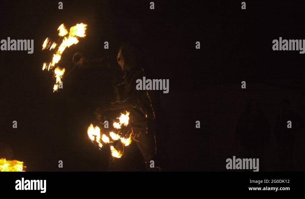 Fiery dance. Amazing magical Fire Show at night. Slow shutter speed ...