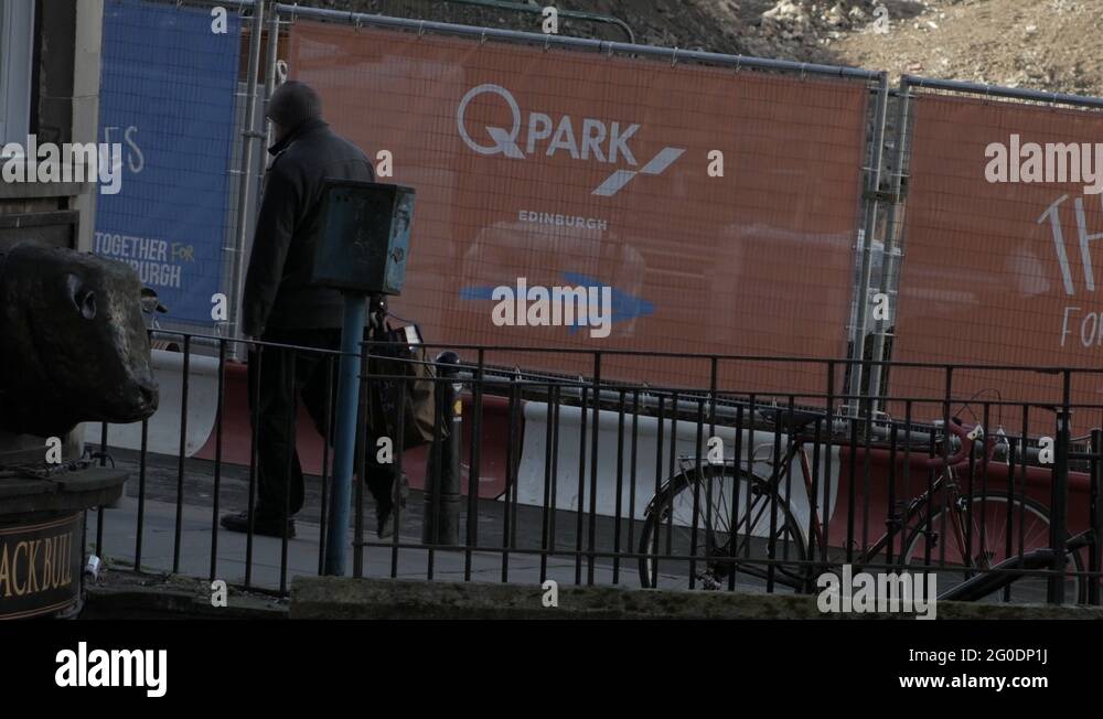 People walking past construction barrier Stock Video Footage - Alamy