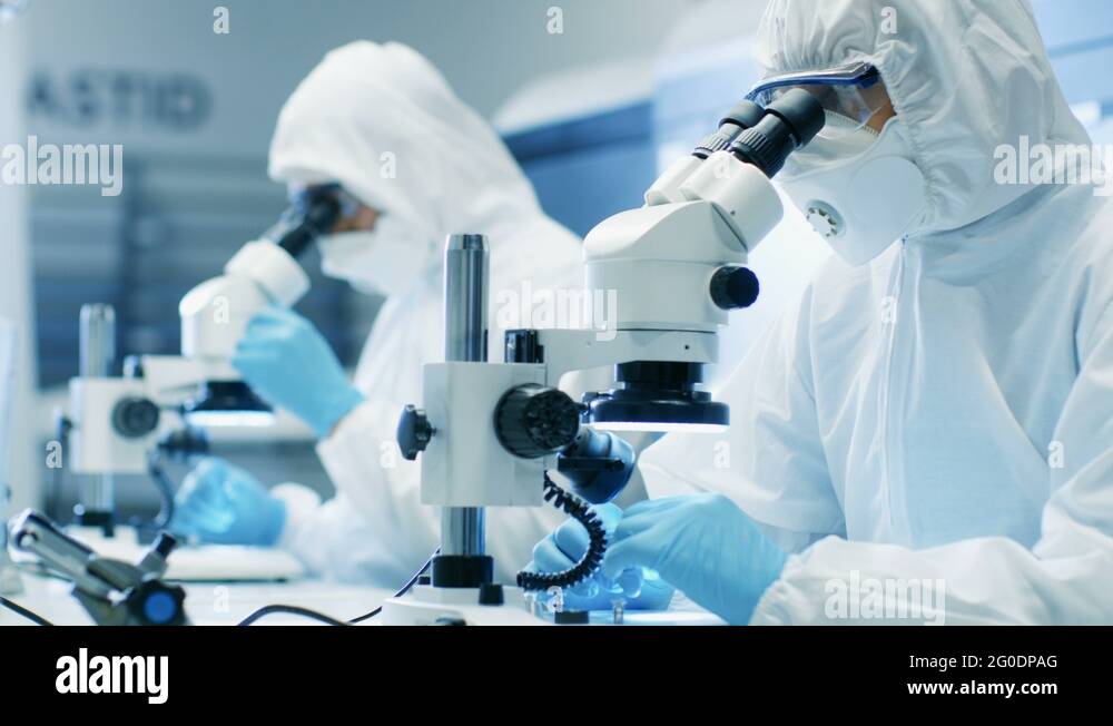 Two Engineers/ Scientists/ Technicians in Sterile Cleanroom Suits Use ...
