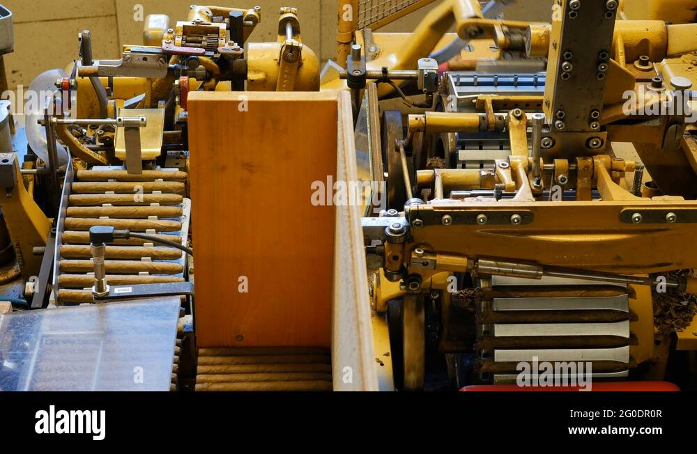 Cigar rolling machine inside a cigar factory producing homemade cigars ...