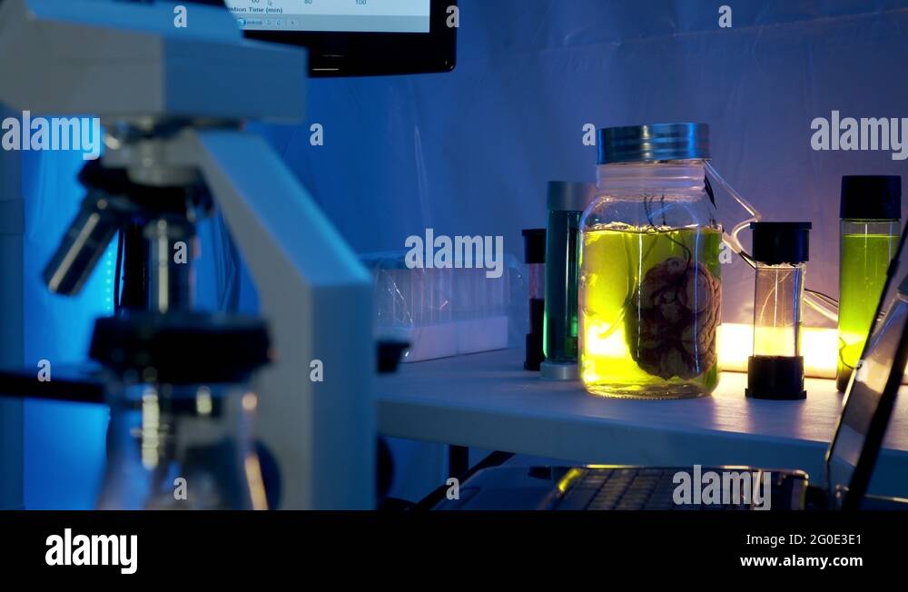 dolly sci-fi looking scene in a hazmat lab of a brain in specimen jar ...