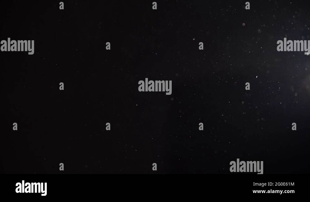 Dust particles in a light beam in a black room background Stock Video ...