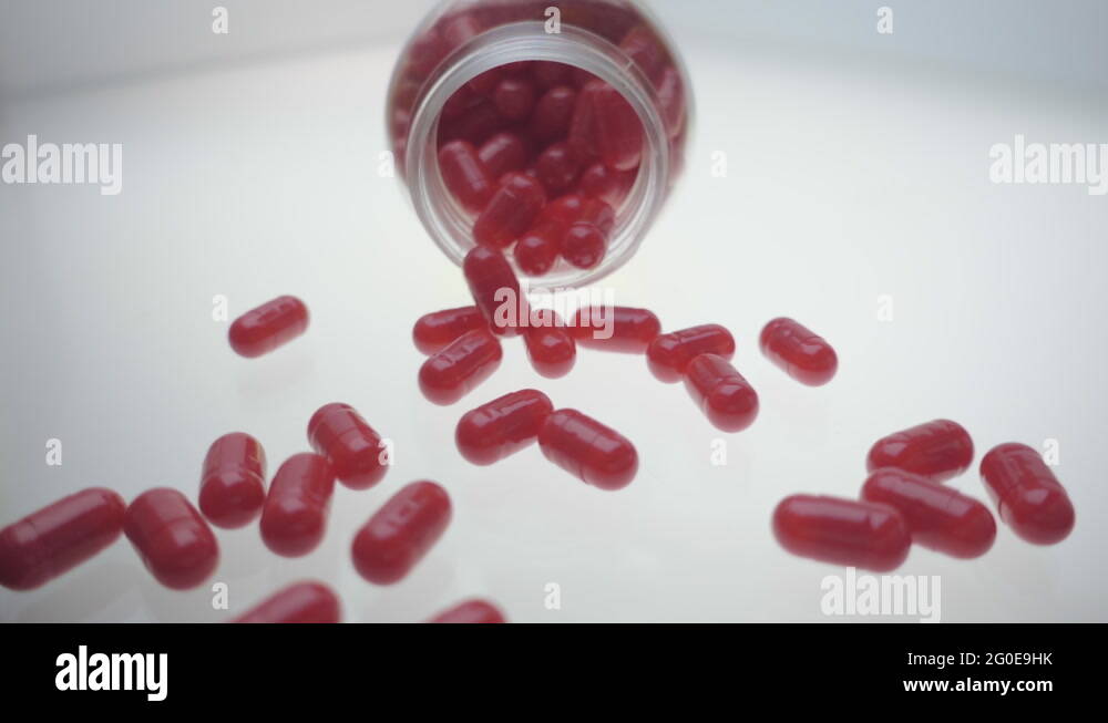 Colorful capsules of the medication is falling down and crumble from ...