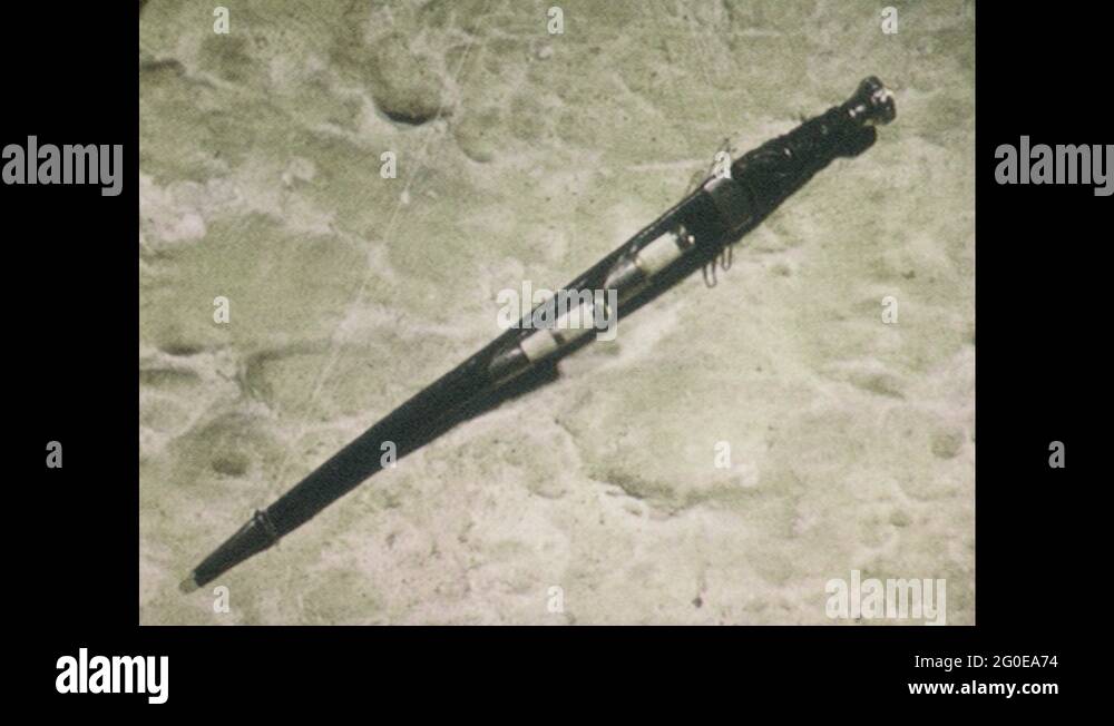 1940s: Hand takes sword from wall. Ax hanging on wall. Hand takes spear ...