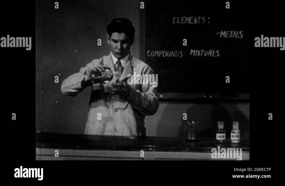 1940s: Scientist holds test tube of carbon disulfide and iron and ...
