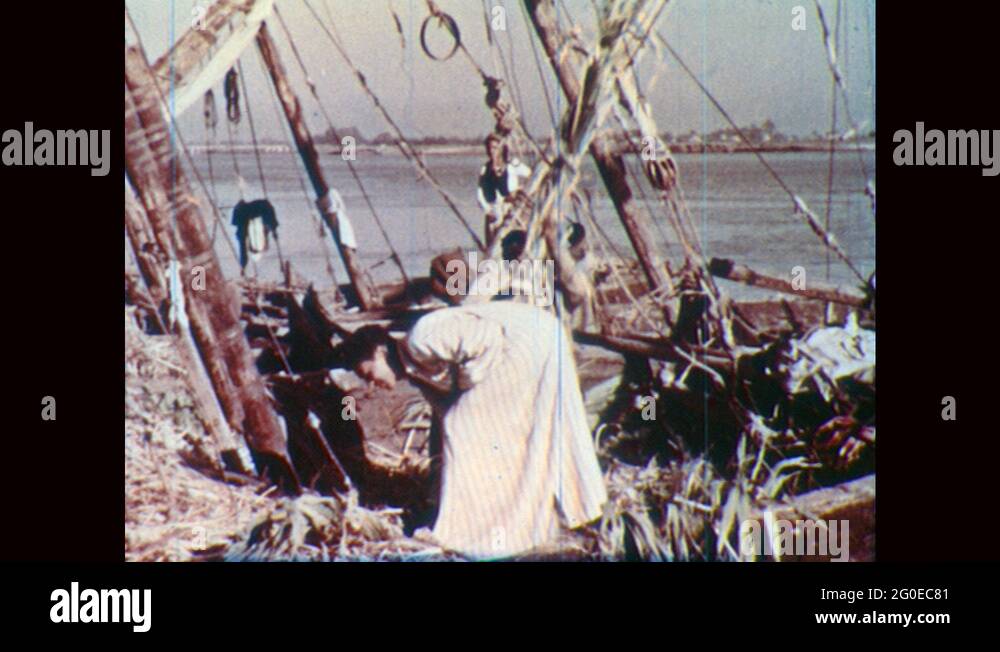 1950s: EGYPT: men load sugar cane onto boat. Sugar cane landed by hand ...