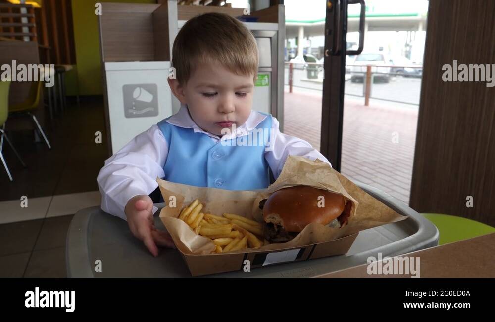 Boy child refuses to eat fast food french fries and burger, he puts ...