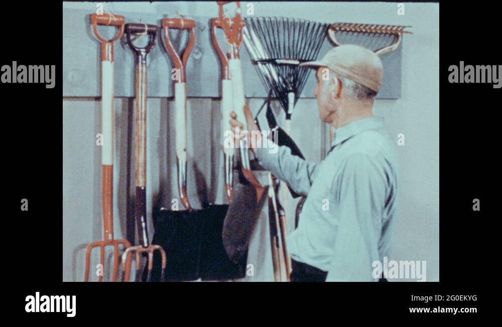1940s: UNITED STATES: hands work cash register. People in street in ...
