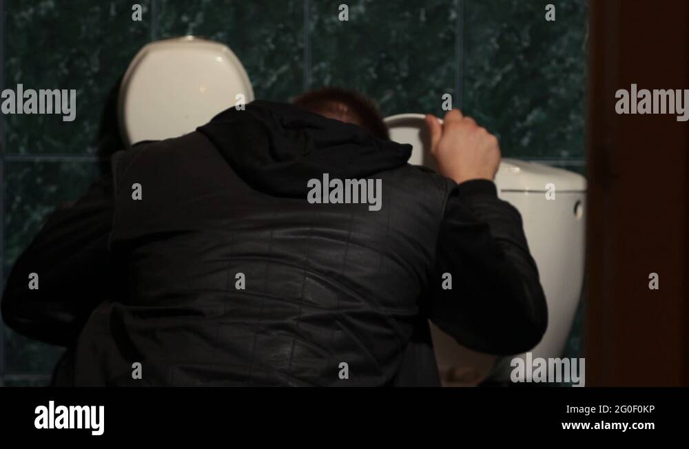 Man Vomiting in the toilet Stock Video Footage - Alamy