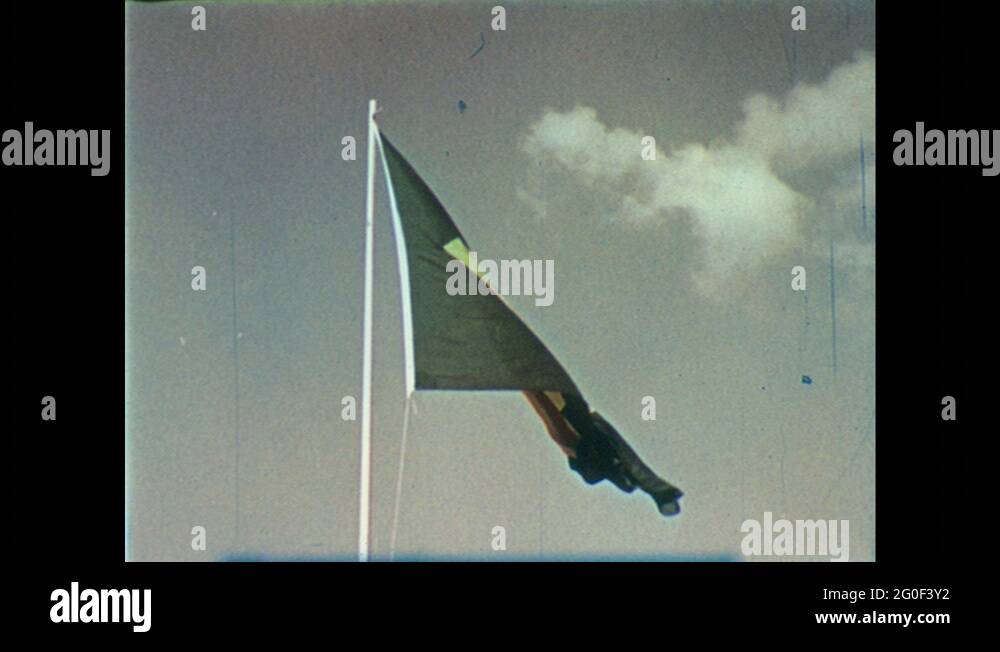 1950s: Flag waves. People walk past soldiers. People walk up ramp. Top ...