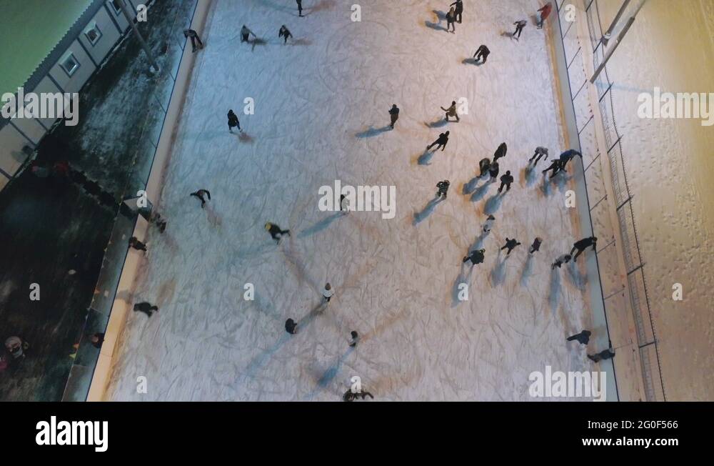 People are skating on ice rink. Aerial vertical top-down view Stock ...