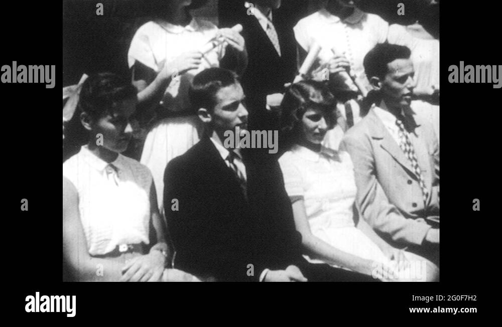 1950s: High school graduation day. Line of teens receive diplomas Stock ...