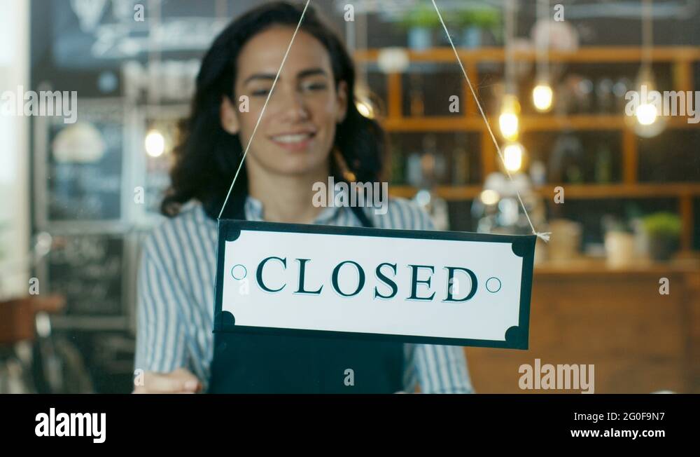 Beautiful Young Cafe Owner Flipping Storefront Sign From Close to Open ...