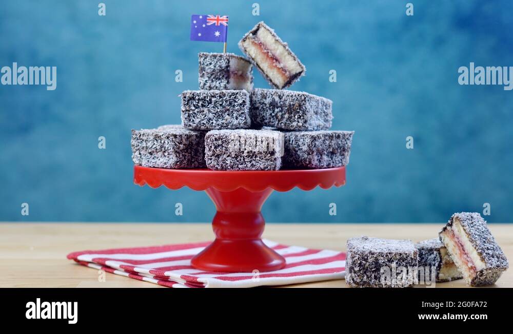 Iconic traditional Australian party food, Lamington cake, on a red ...