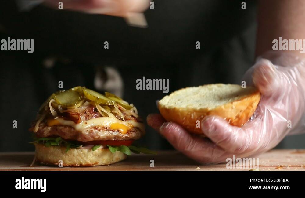 The process of cooking big Burger is a professional chef, close-up ...