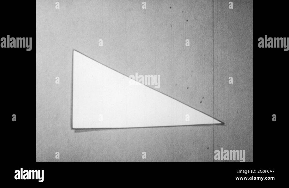 1950s: UNITED STATES: schematic of inclined plane. Hands roll paper ...