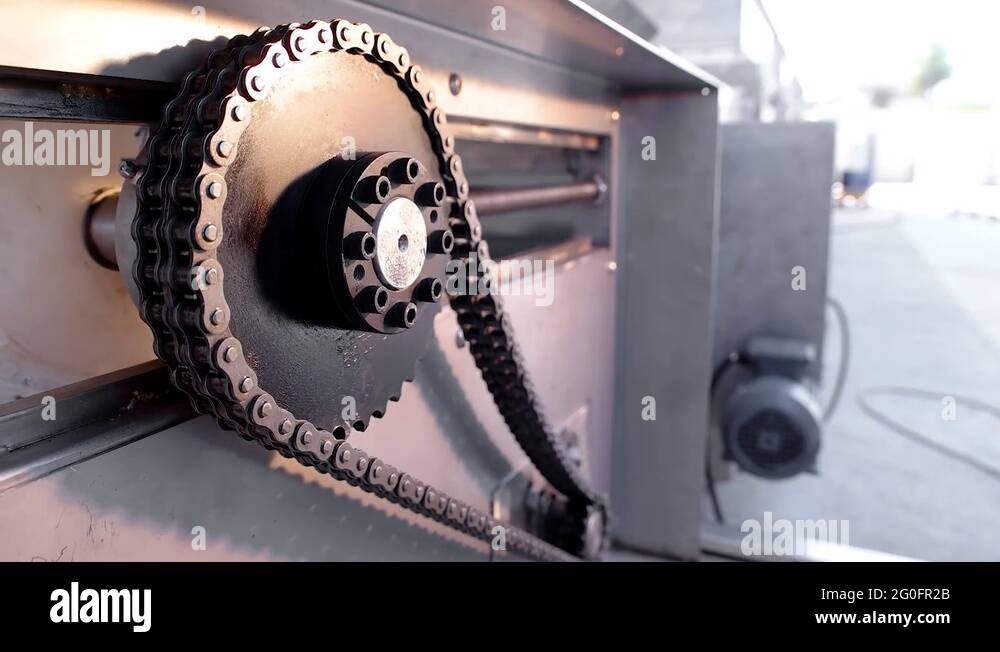 Metal pulley belt and gears with chain turning. Close up. Slow motion ...