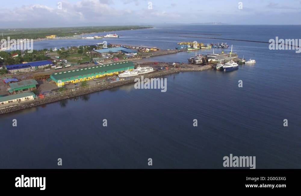 Fishing port and dock yard where boats are anchored side by side. Drone ...