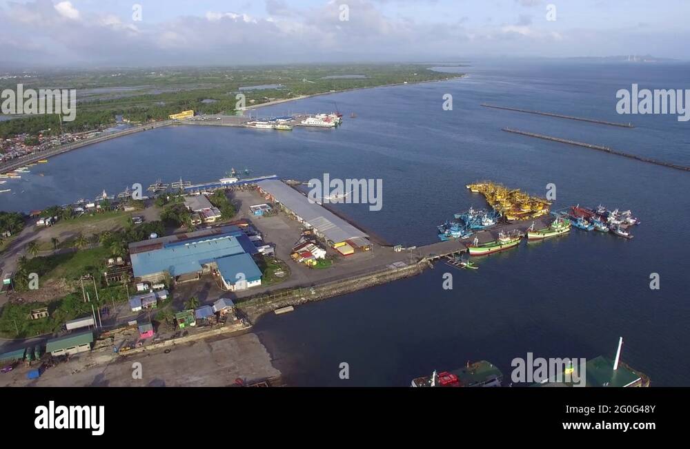 Fishing port and dock yard where boats are anchored side by side. Drone ...