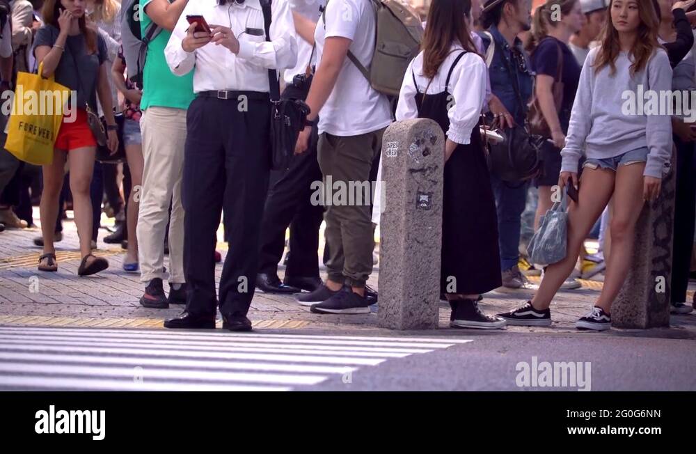 People cross the famous intersection in Shibuya, Tokyo, Japan Stock ...