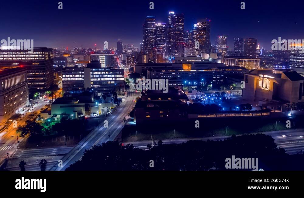 Cinematic aerial view of urban downtown streets and city skyline at ...