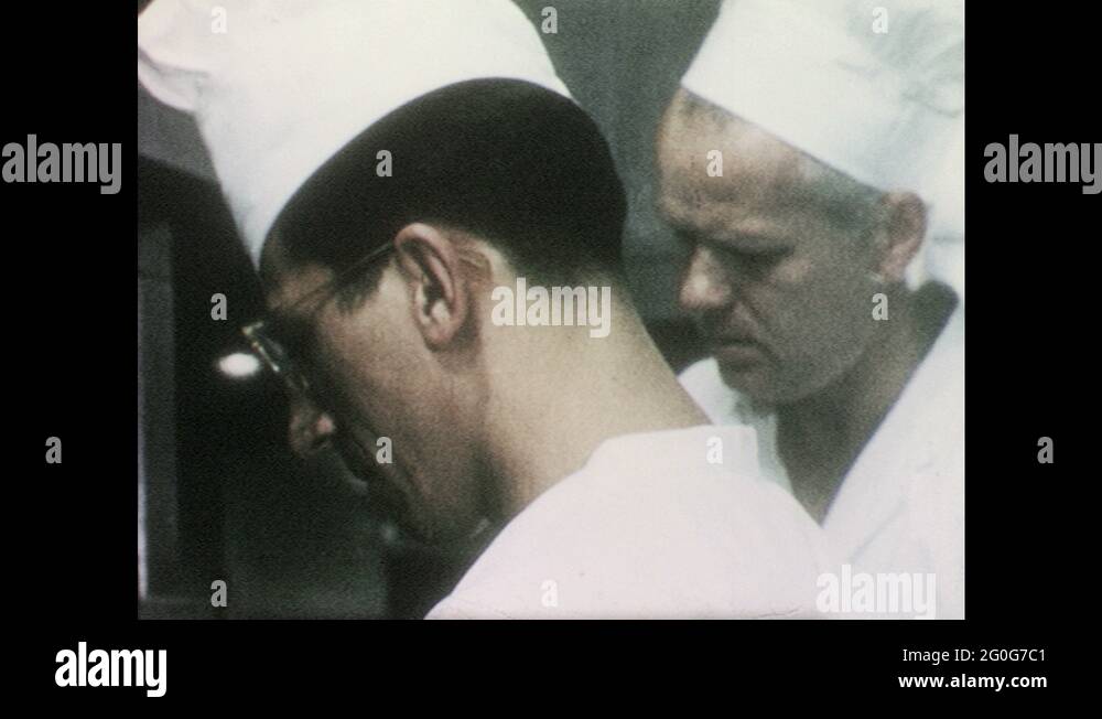 1950s: Men in chef uniforms. Hands prepare meat. Train moves along ...