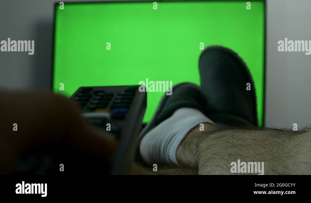Man Hand With Remote Controller Changing Channels On A Green Screen TV ...
