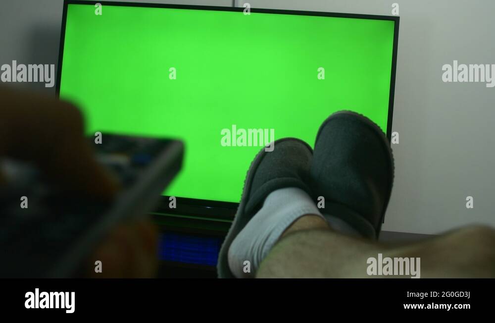 Man Hand With Remote Controller Changing Channels On A Green Screen TV ...