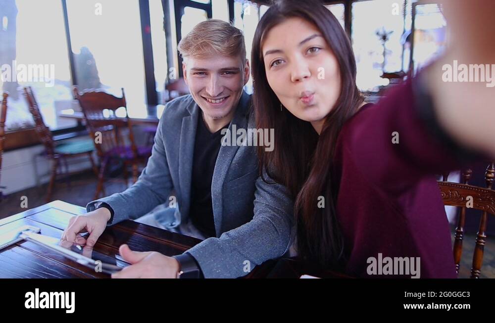 Jocund couple making selfie, using tablet and sticking out tongue Stock ...