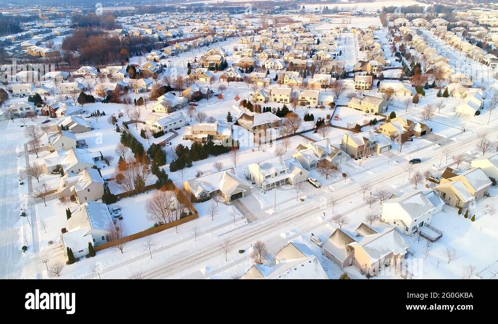 Beautiful neighborhoods, homes frozen under snow and ice, aerial view ...