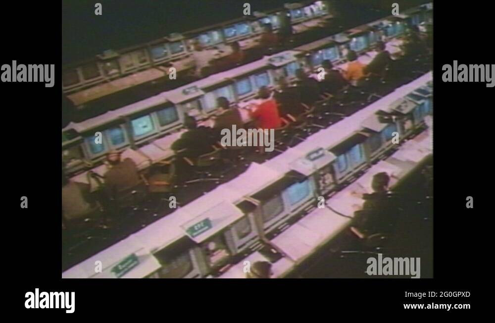 1980s: People in Nasa mission control room. Astronauts wait. Countdown ...