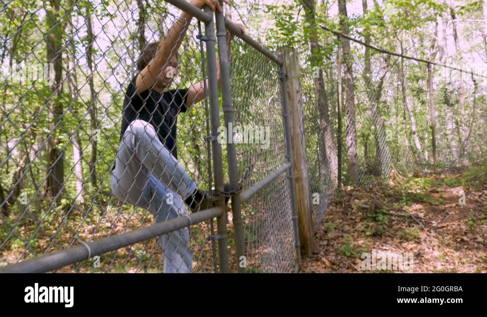 Young man on chain link fence Stock Videos & Footage - HD and 4K Video ...