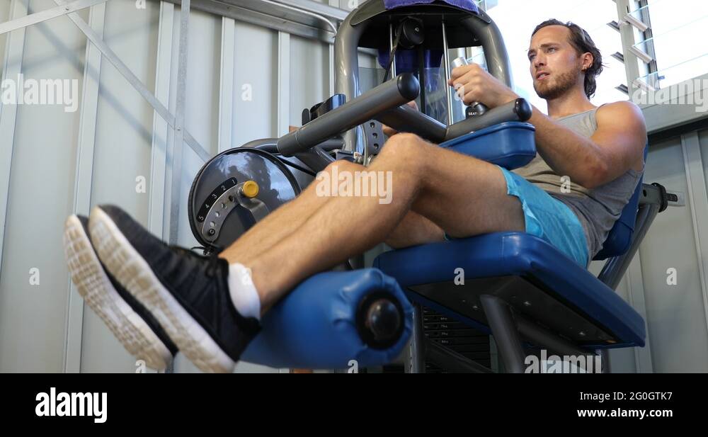 Fitness Man doing hamstring curls in Leg Curl Machine aka Hamstring ...