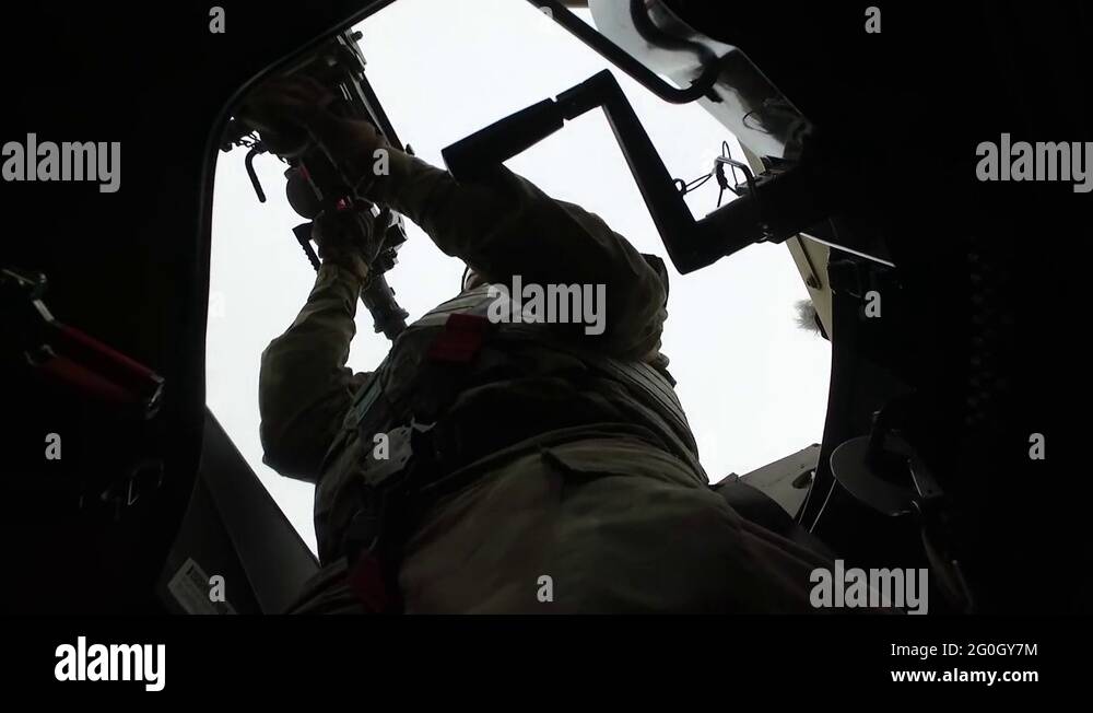 Soldier firing Grenade launcher mounted on top of the military jeep ...