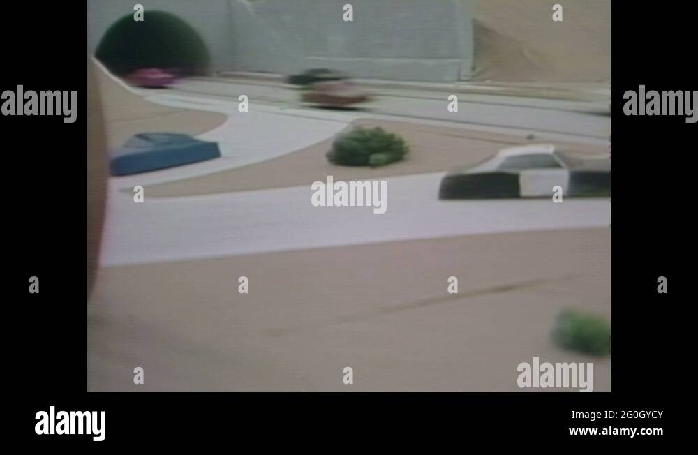 1970s: Model cars move very quickly on a model freeway conveyor belt ...